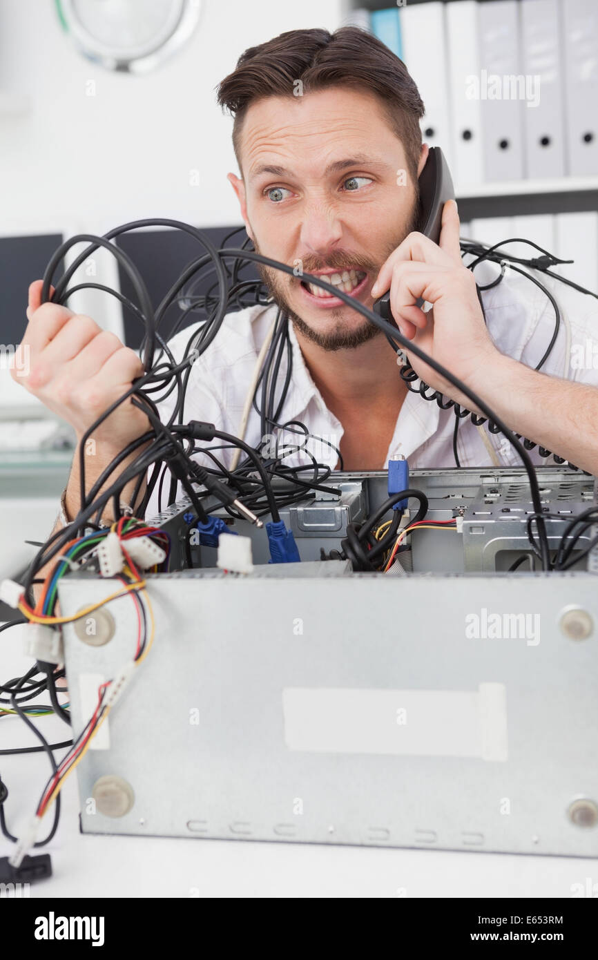 Angry computer engineer making a call Stock Photo - Alamy