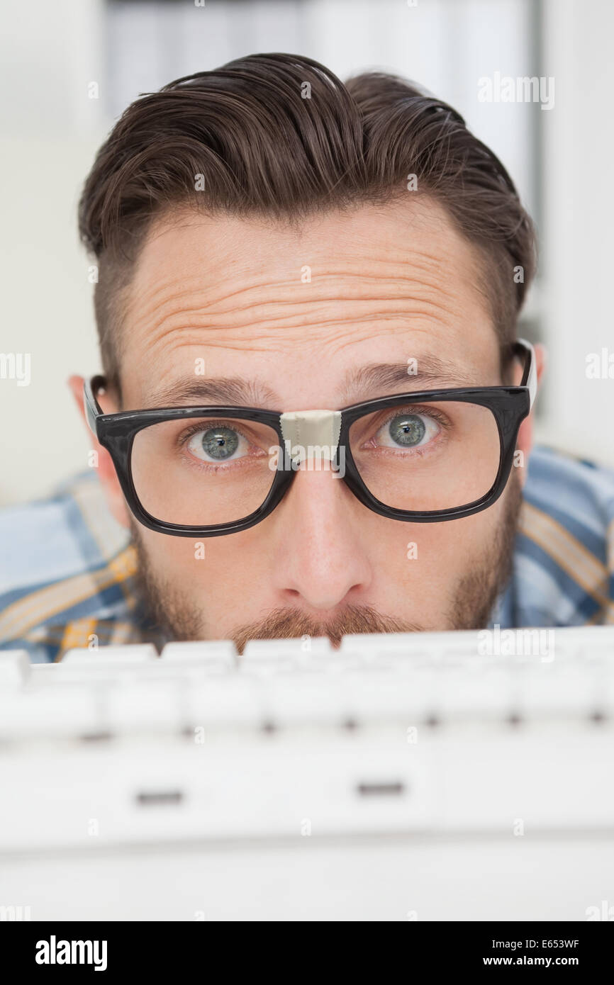 Puzzled nerdy businessman working on computer Stock Photo - Alamy