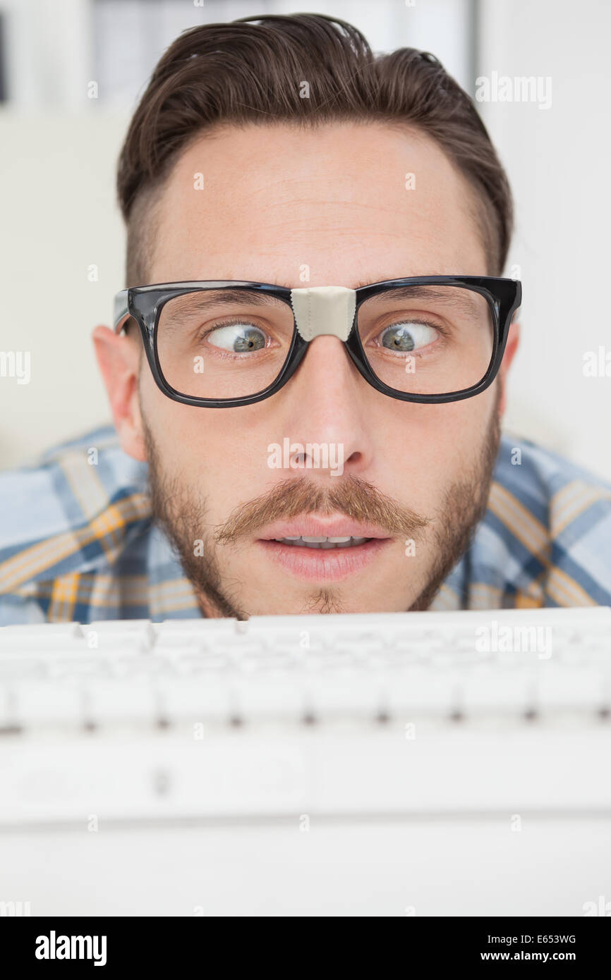 Puzzled nerdy businessman working on computer Stock Photo - Alamy