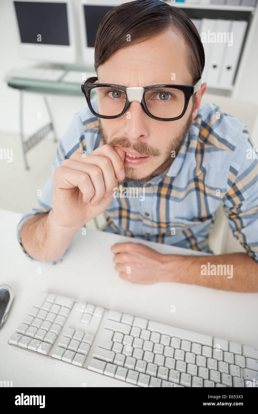 Nerdy nervous businessman working on computer Stock Photo - Alamy