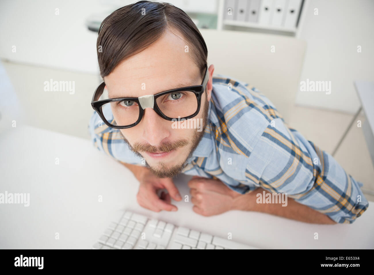 Nerdy businessman working on computer Stock Photo - Alamy