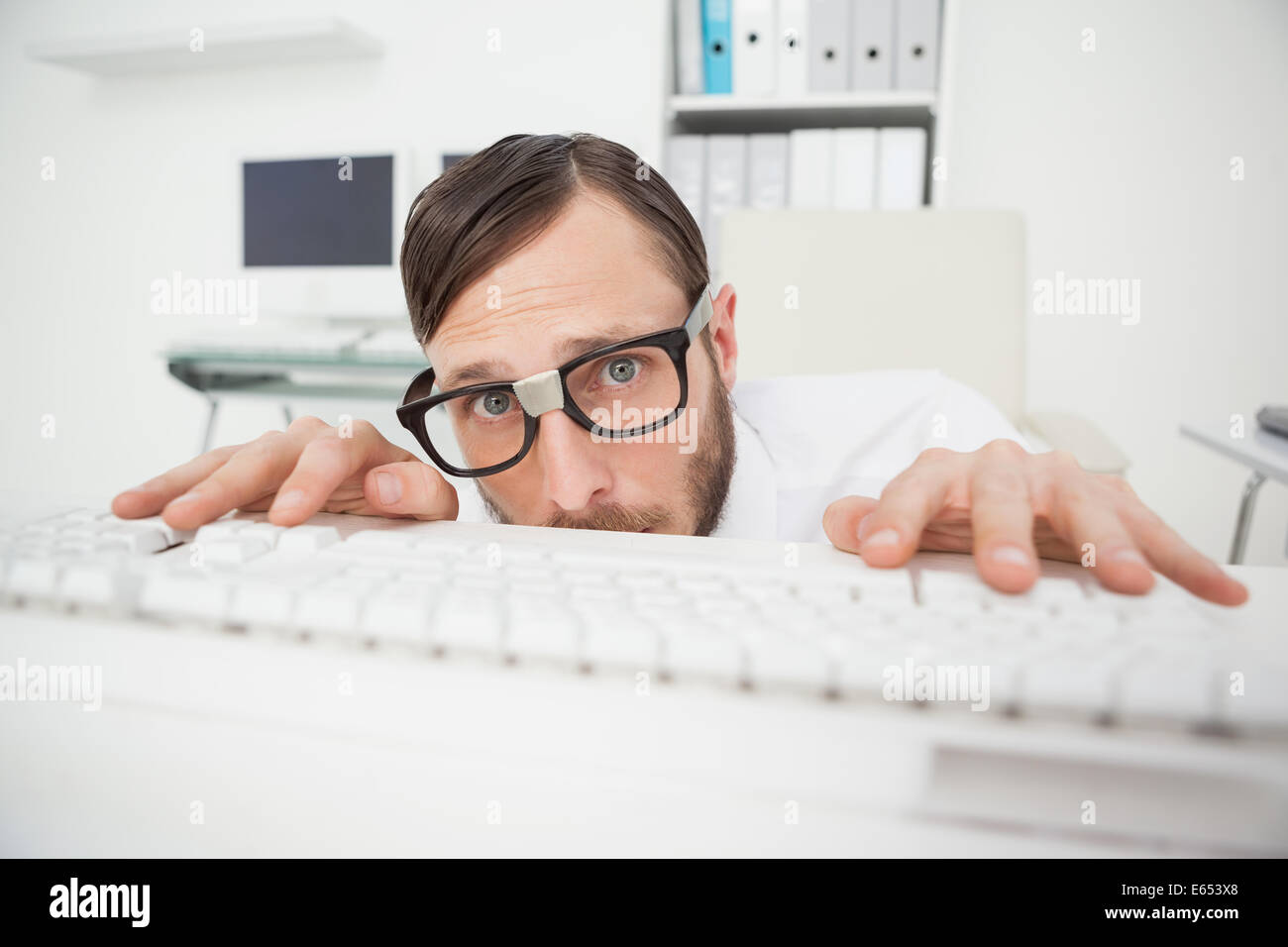 Man Peering At Computer High Resolution Stock Photography and Images ...