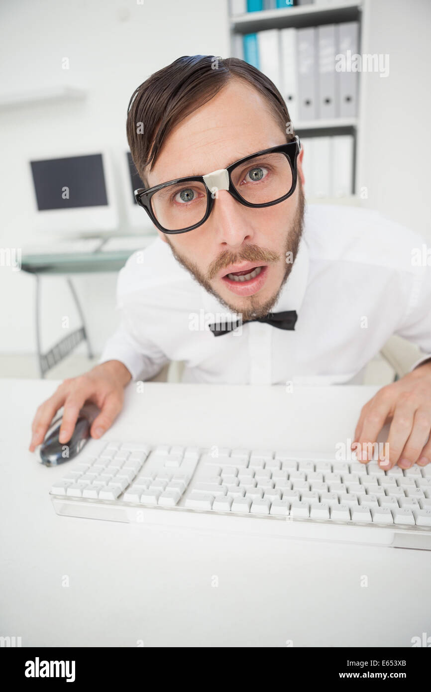 Nerdy shocked businessman working on computer Stock Photo - Alamy