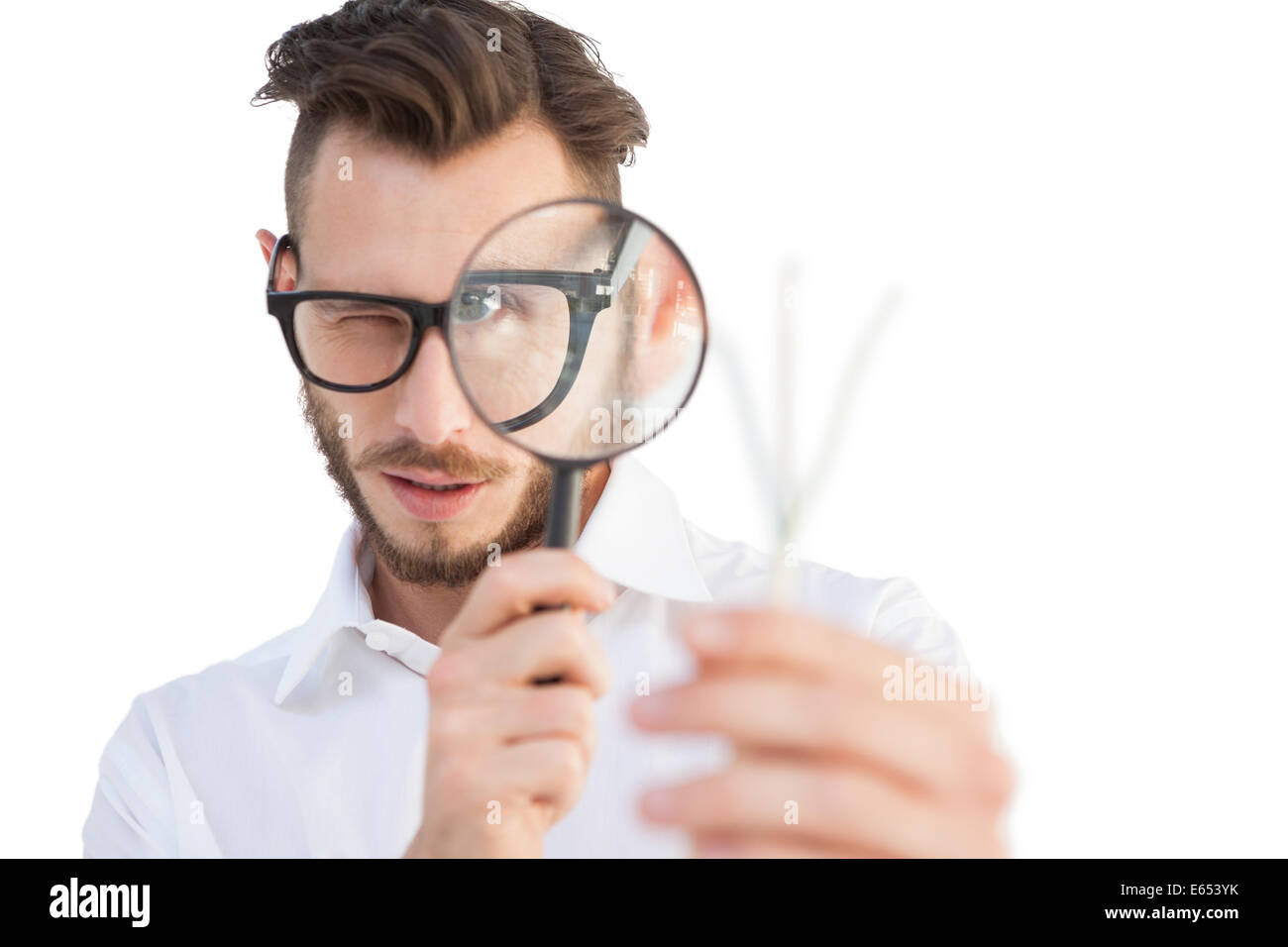 Nerdy businessman looking through magnifying glass Stock Photo - Alamy