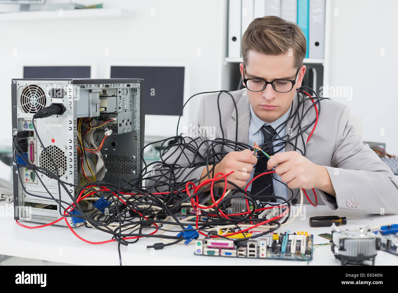Computer engineer working on broken console Stock Photo - Alamy
