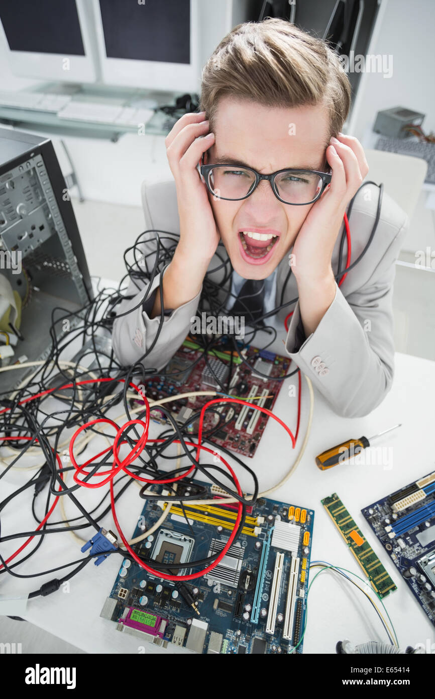 Stressed computer engineer working on broken cables Stock Photo - Alamy