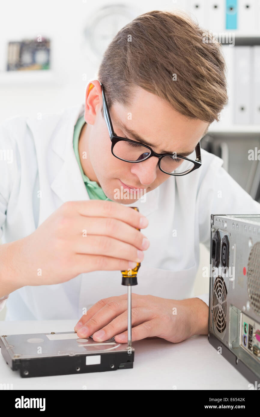 Technician working on broken hardware with screwdriver Stock Photo - Alamy
