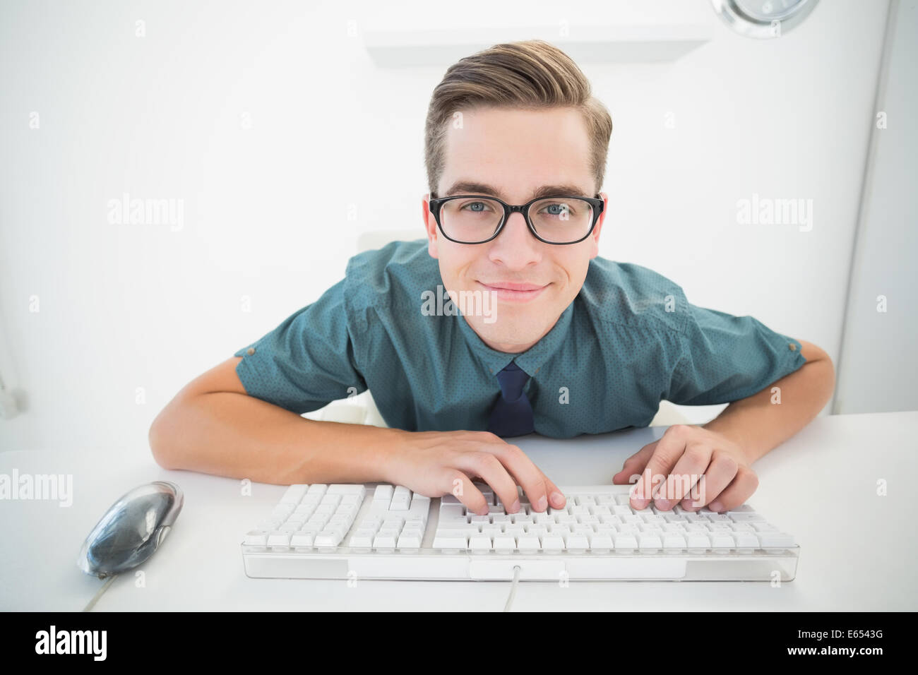Casual businessman typing at his desk Stock Photo - Alamy