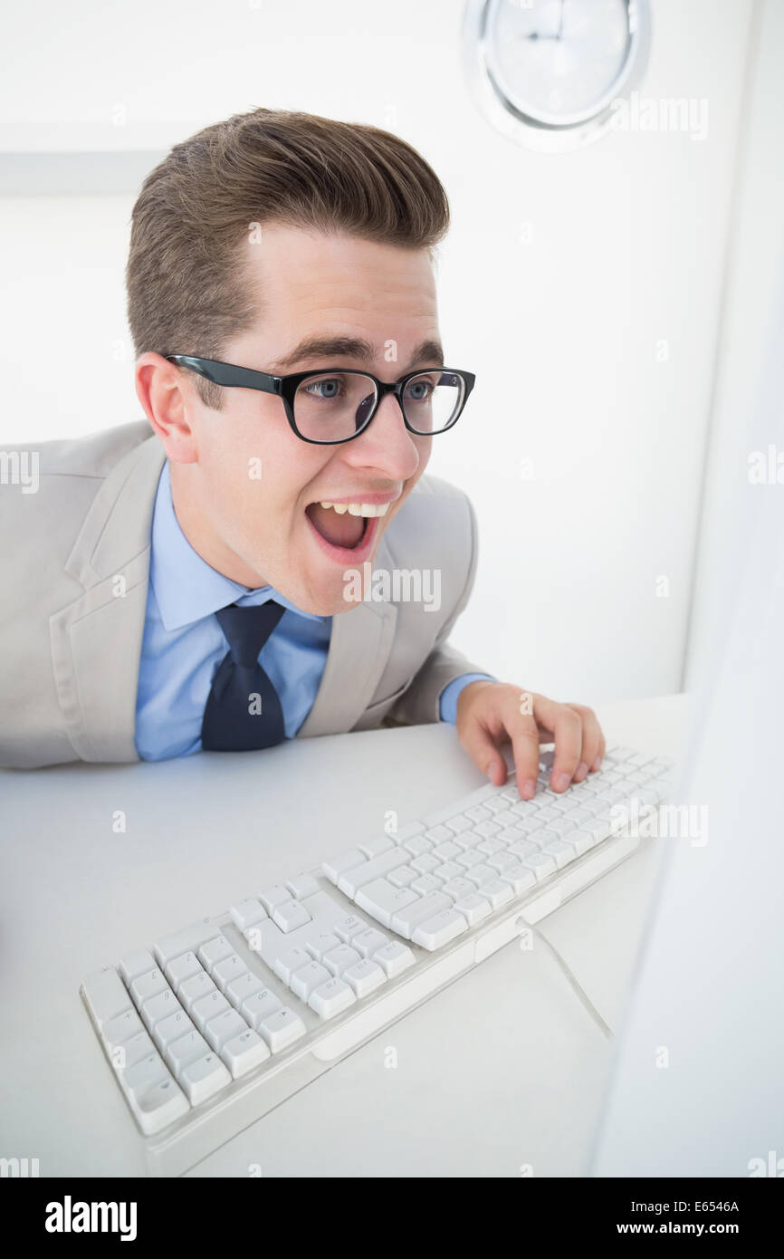 Excited businessman working on computer Stock Photo - Alamy