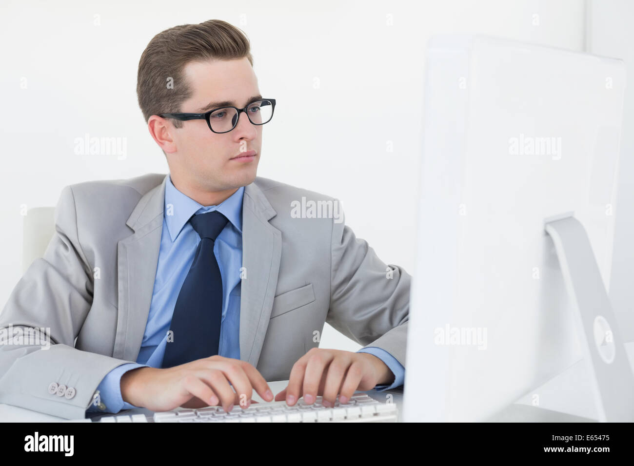Nerdy businessman working on computer Stock Photo - Alamy