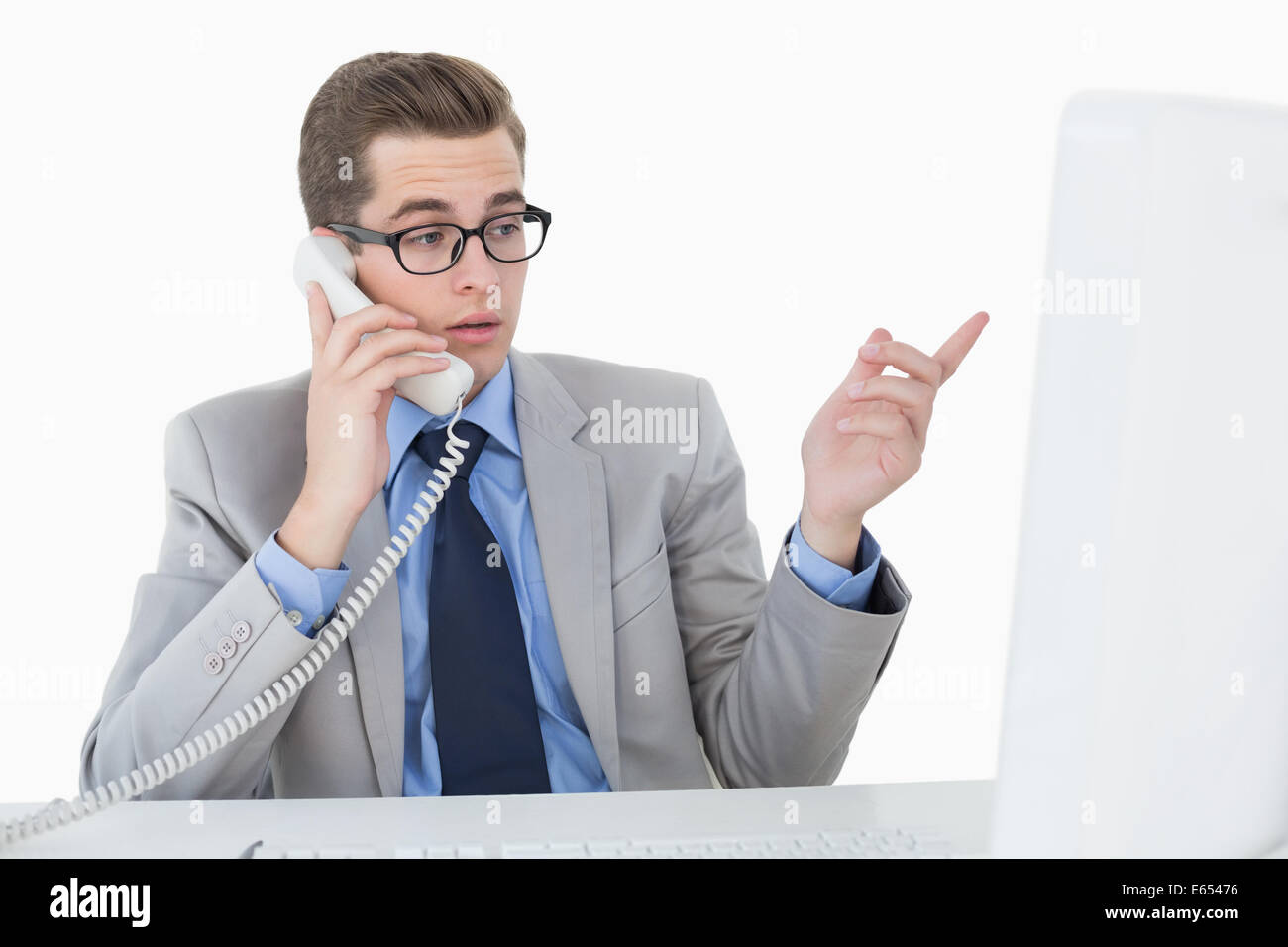 Nerdy businessman working on computer talking on phone Stock Photo - Alamy