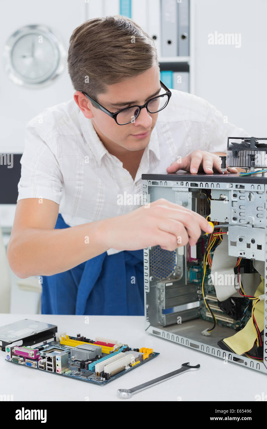 Young technician working on broken computer Stock Photo - Alamy