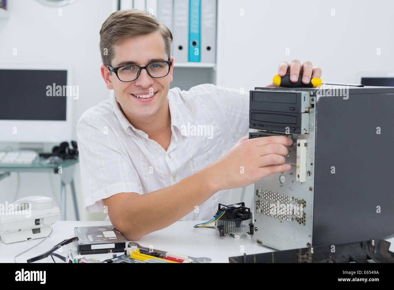 Young technician working on broken computer Stock Photo - Alamy