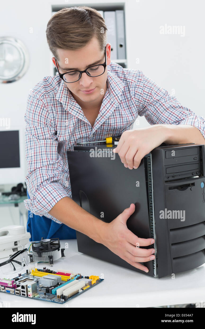 Young technician working on broken computer Stock Photo - Alamy