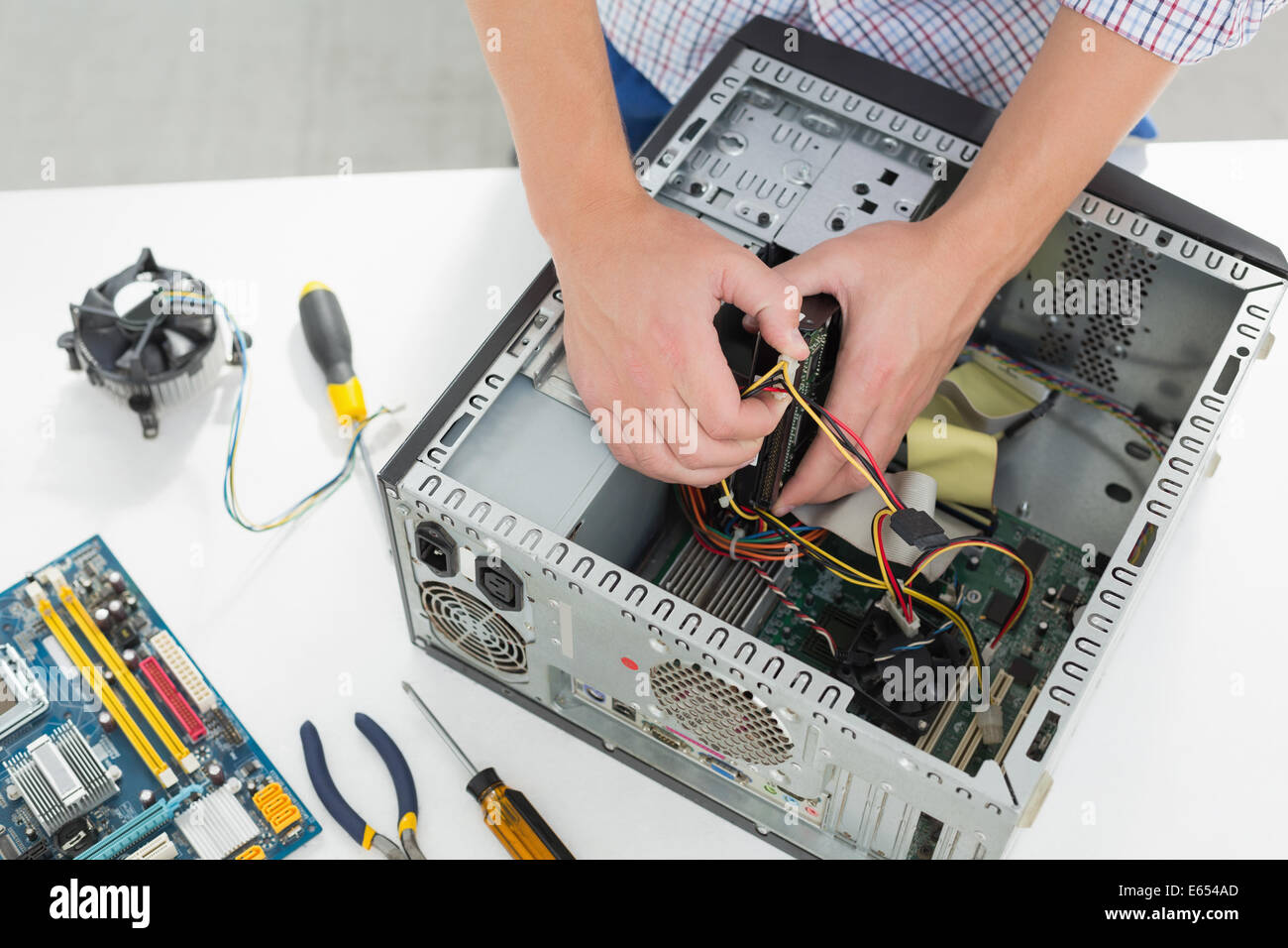Young technician working on broken computer Stock Photo - Alamy