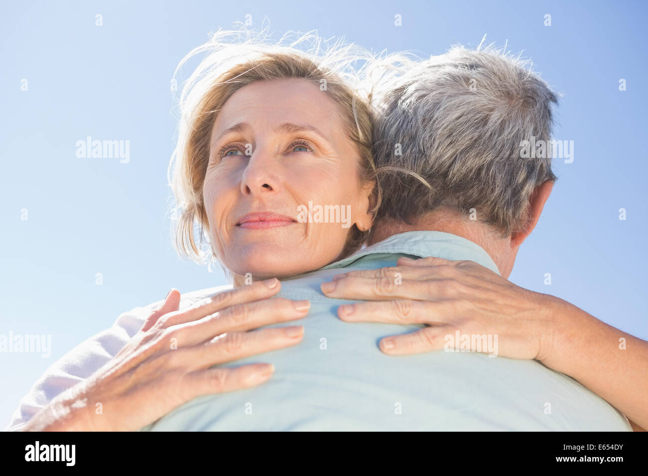 Senior woman hugging her partner Stock Photo - Alamy
