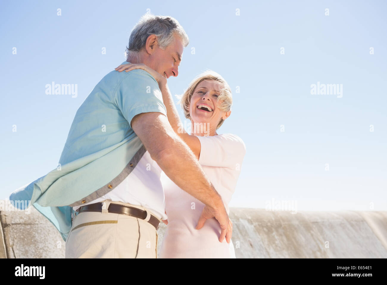 Senior woman hugging her partner Stock Photo - Alamy