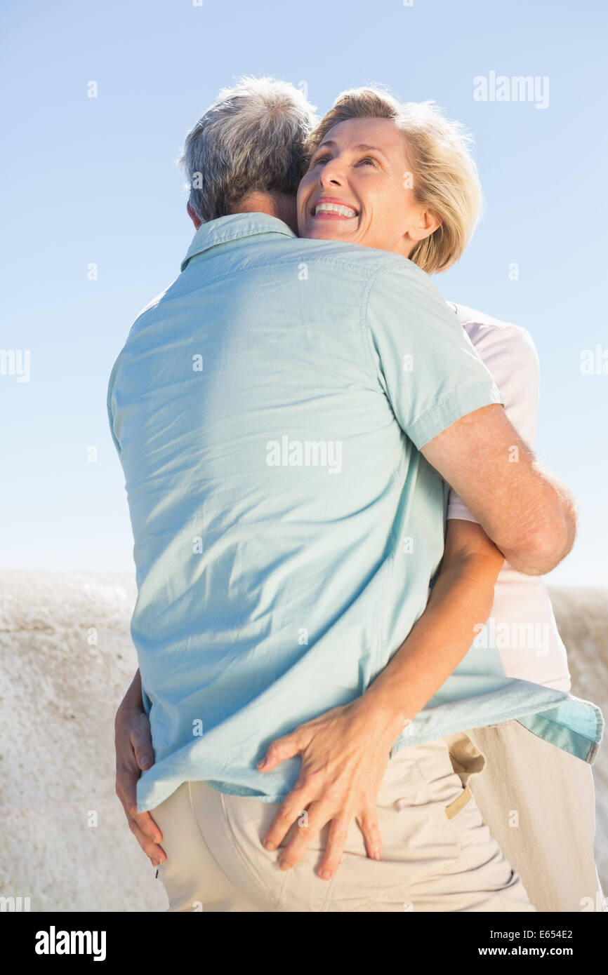 Senior woman hugging her partner Stock Photo - Alamy