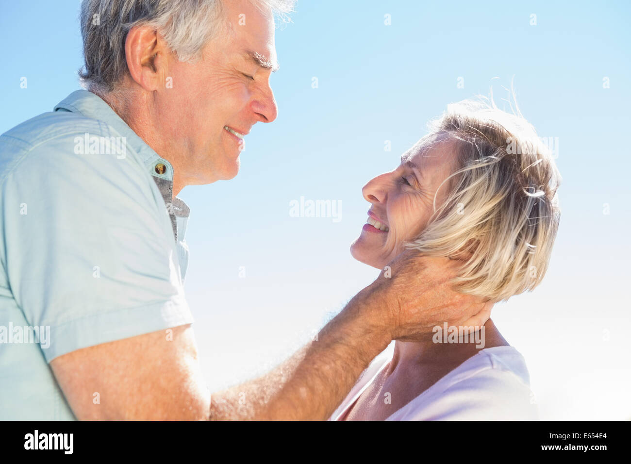 Senior woman hugging her partner Stock Photo - Alamy