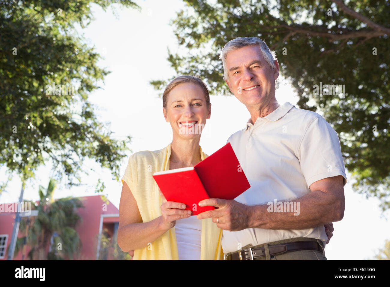 Happy senior couple using the guidebook Stock Photo - Alamy