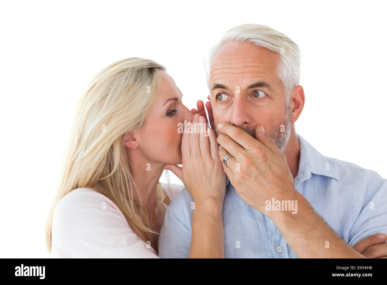 Woman whispering a secret to husband Stock Photo - Alamy