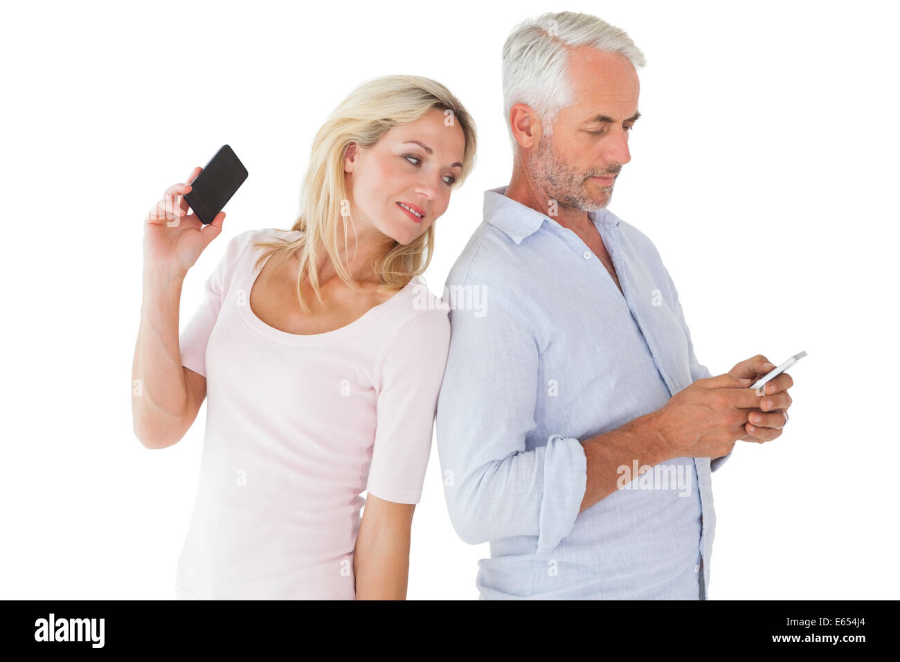 Happy couple texting on their smartphones Stock Photo - Alamy