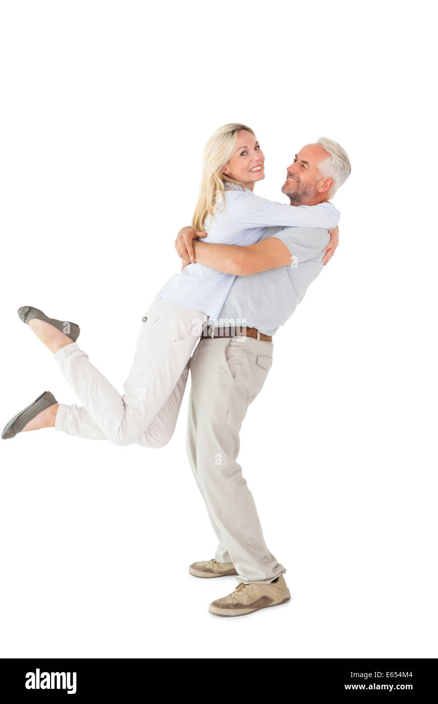 Man picking up his partner while hugging here Stock Photo - Alamy