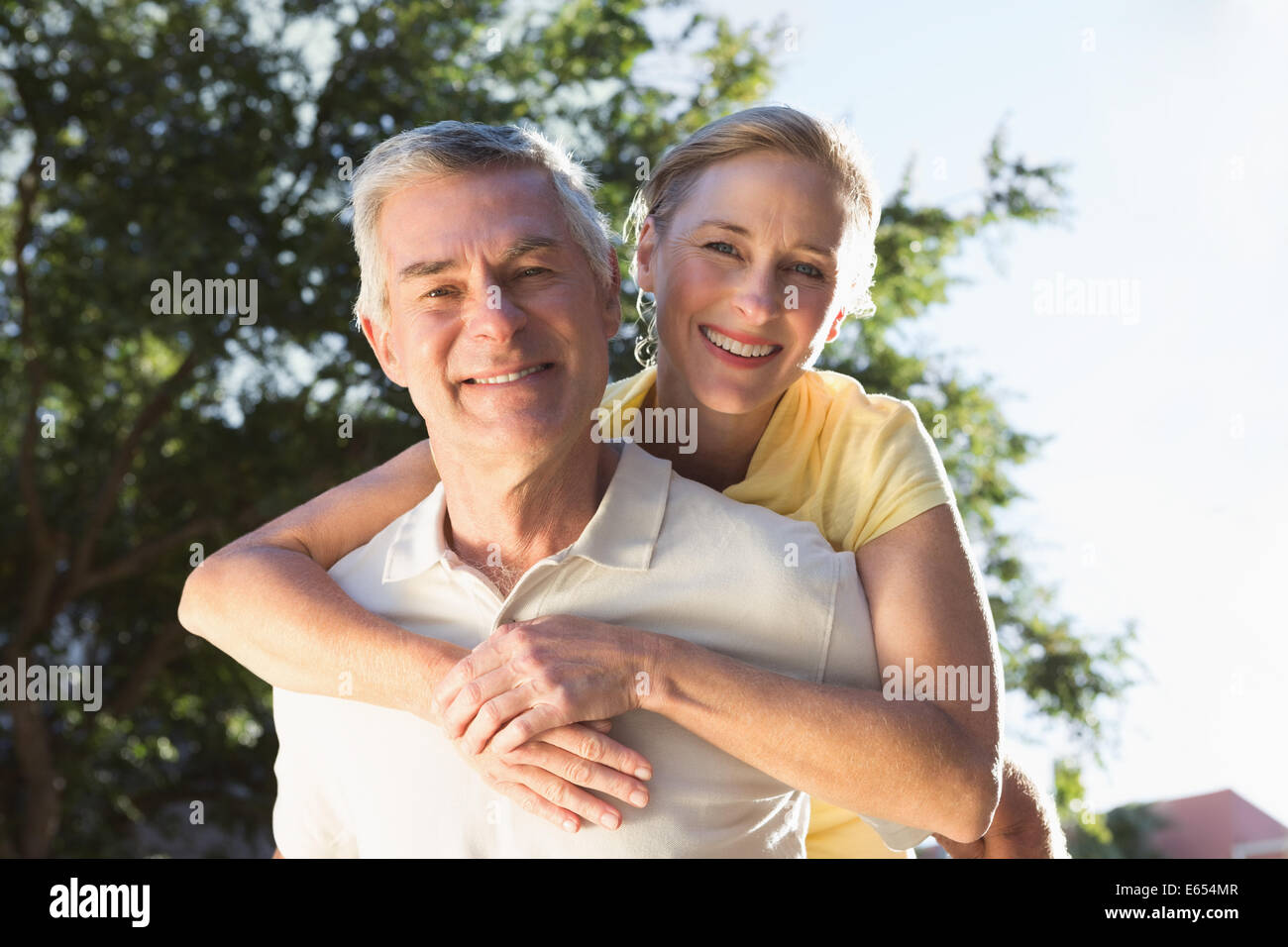 Happy senior man giving his partner a piggy back Stock Photo - Alamy