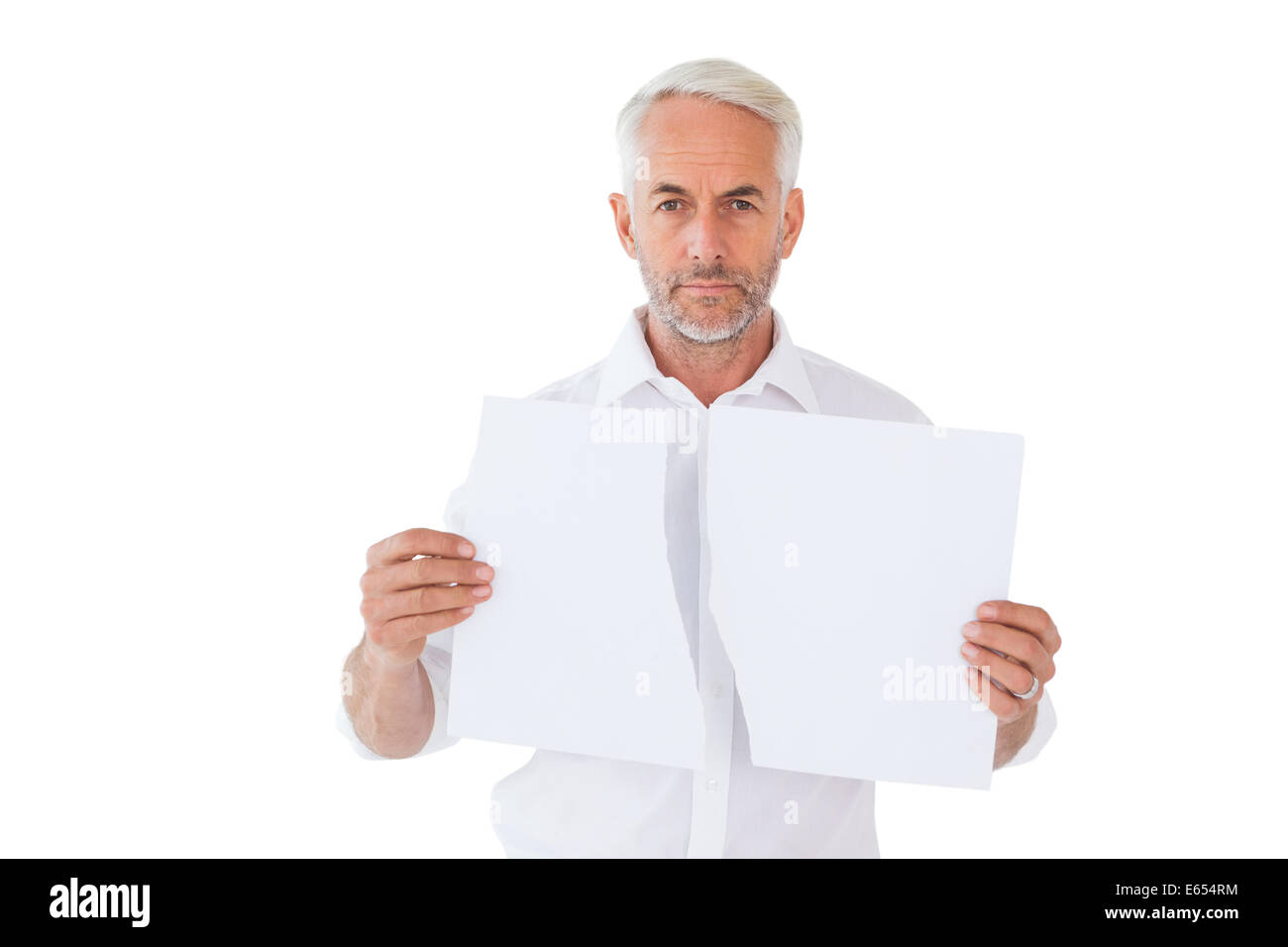 Serious man holding torn sheet of paper Stock Photo - Alamy