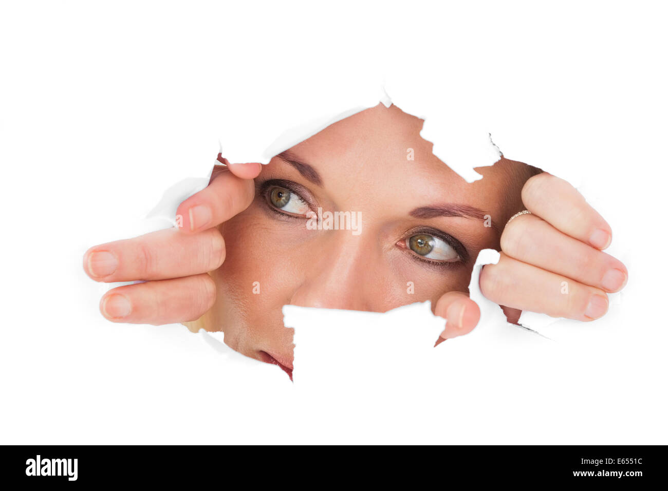 Woman looking through torn paper Stock Photo - Alamy