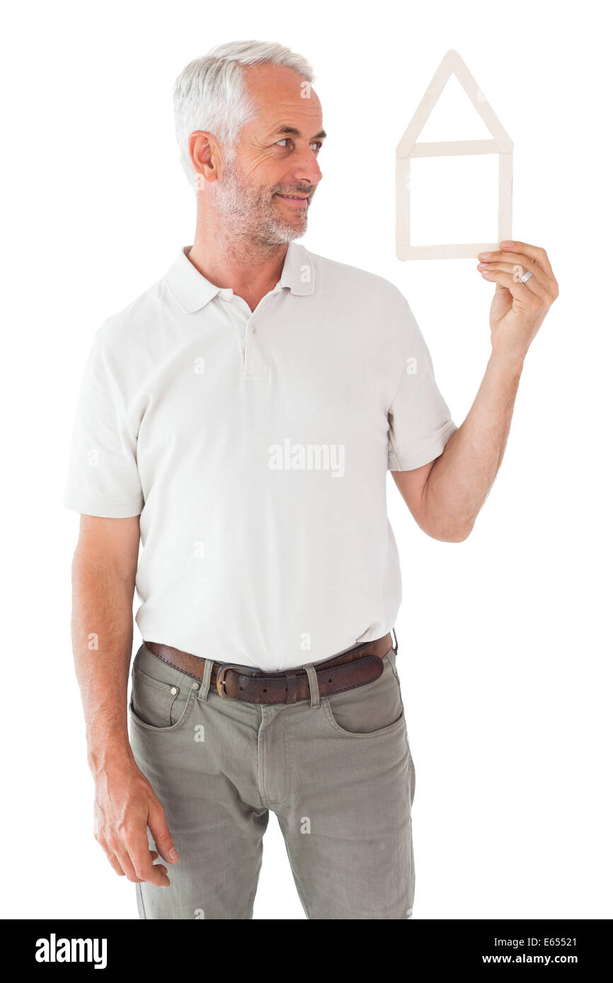 Happy man holding house outline Stock Photo - Alamy