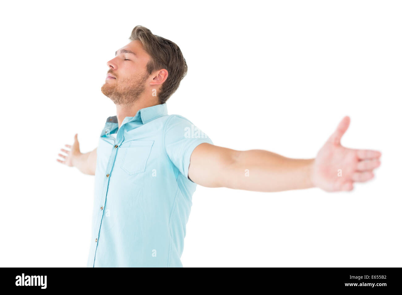 Handsome young man posing with arms out Stock Photo - Alamy