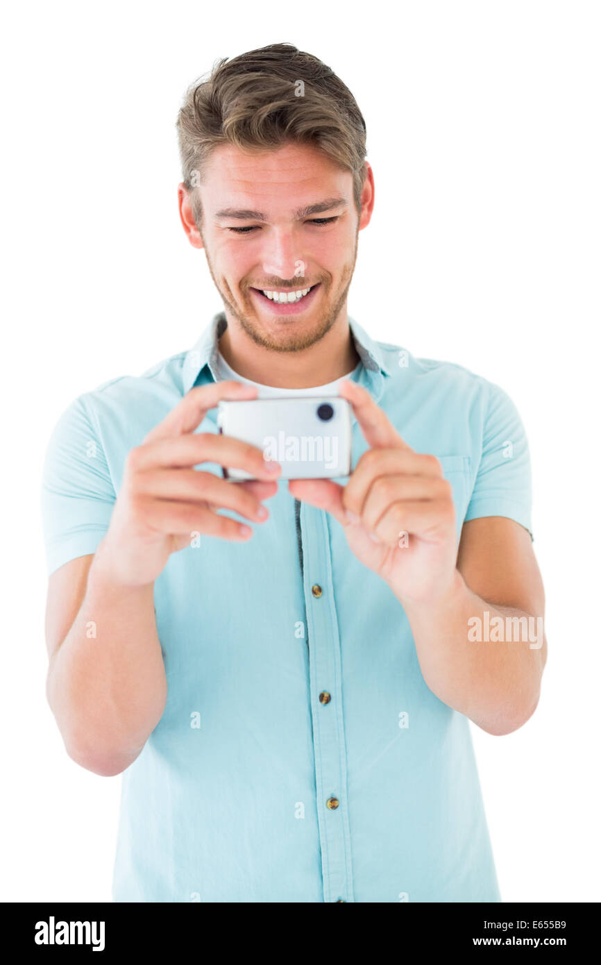 Handsome young man taking photo with smartphone Stock Photo - Alamy