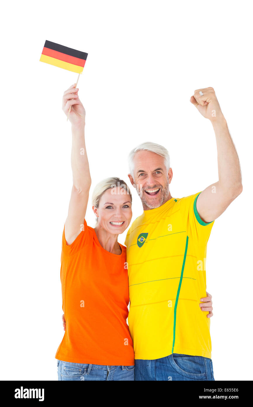 Football fan couple cheering and smiling at camera Stock Photo - Alamy