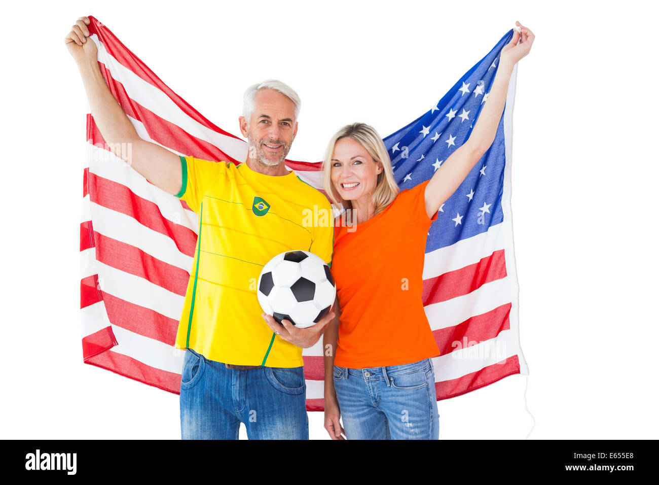 Football fan couple cheering and smiling at camera Stock Photo - Alamy