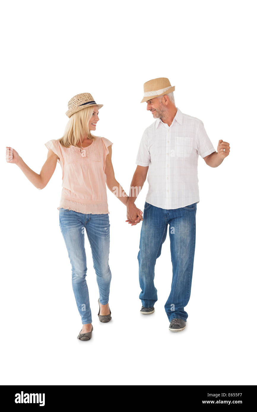 Happy couple walking holding hands Stock Photo - Alamy