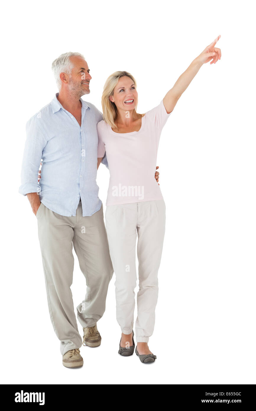 Smiling couple walking and pointing Stock Photo - Alamy