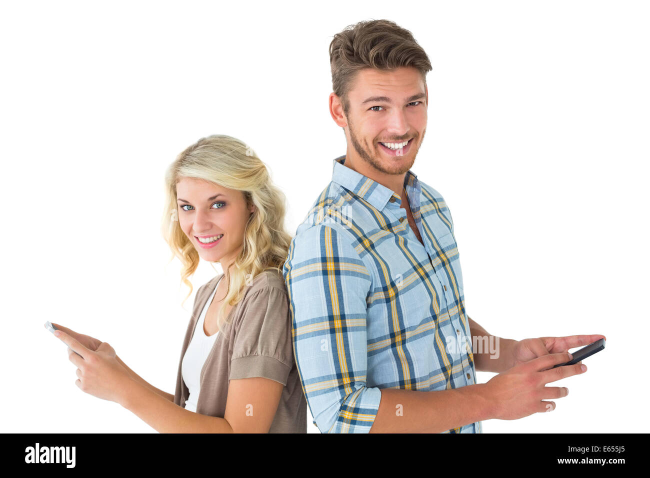 Attractive couple using their smartphones Stock Photo - Alamy