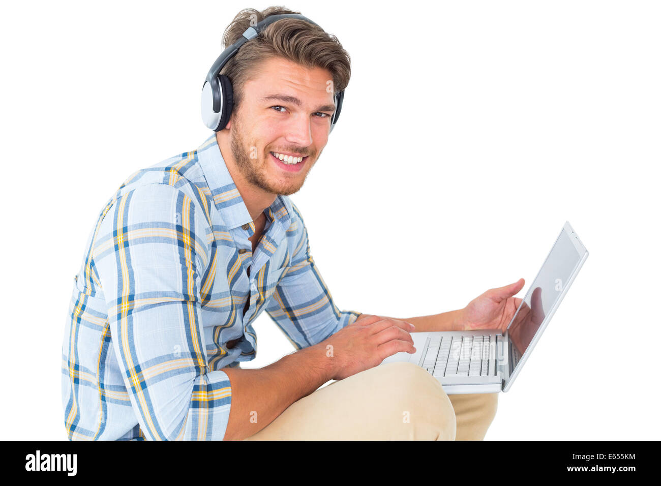 Handsome young man sitting using laptop Stock Photo - Alamy