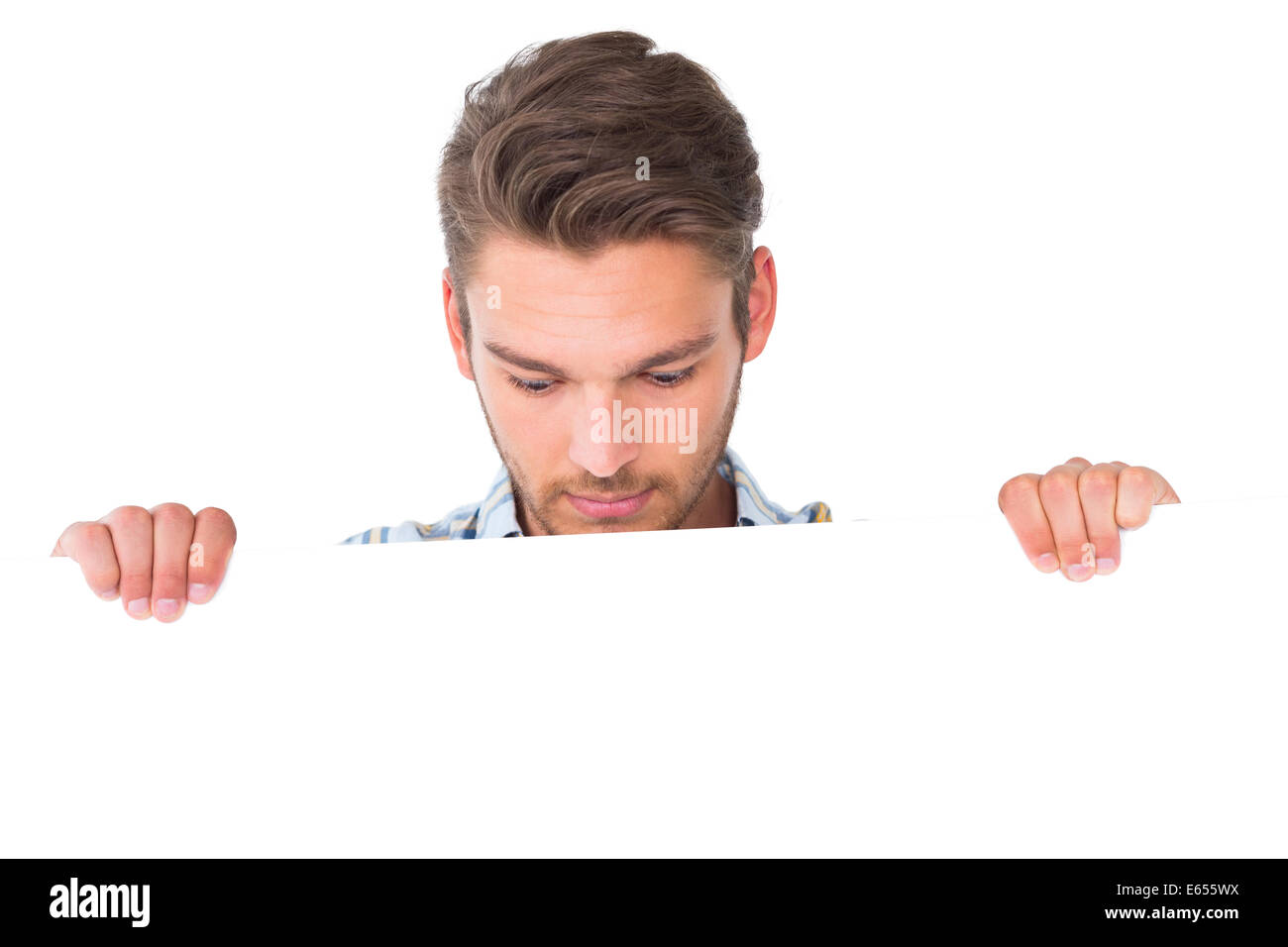 Handsome young man showing poster Stock Photo - Alamy