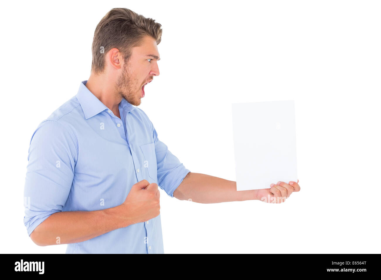 Angry man looking at page Stock Photo - Alamy