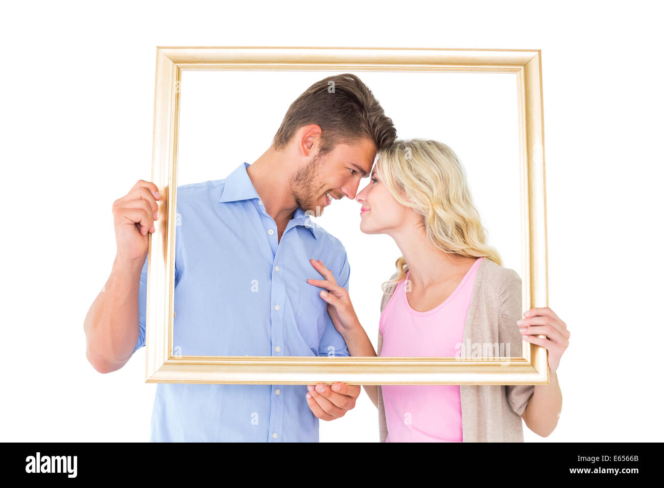 Attractive young couple holding picture frame Stock Photo - Alamy
