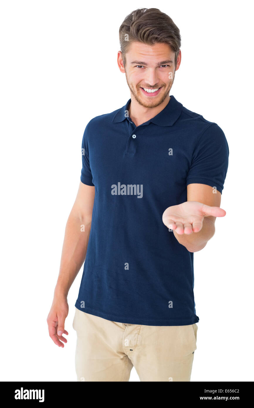 Handsome young man holding his hand out Stock Photo - Alamy