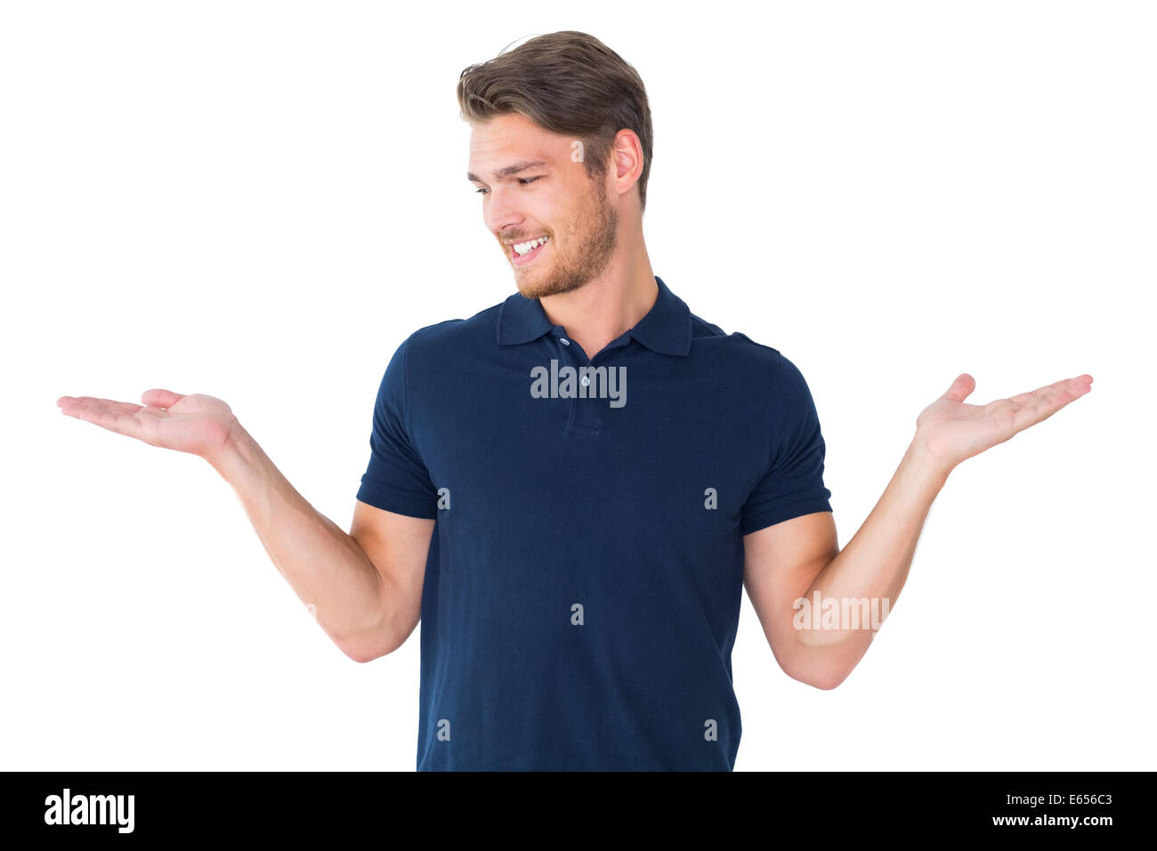 Handsome young man holding his hands out Stock Photo - Alamy