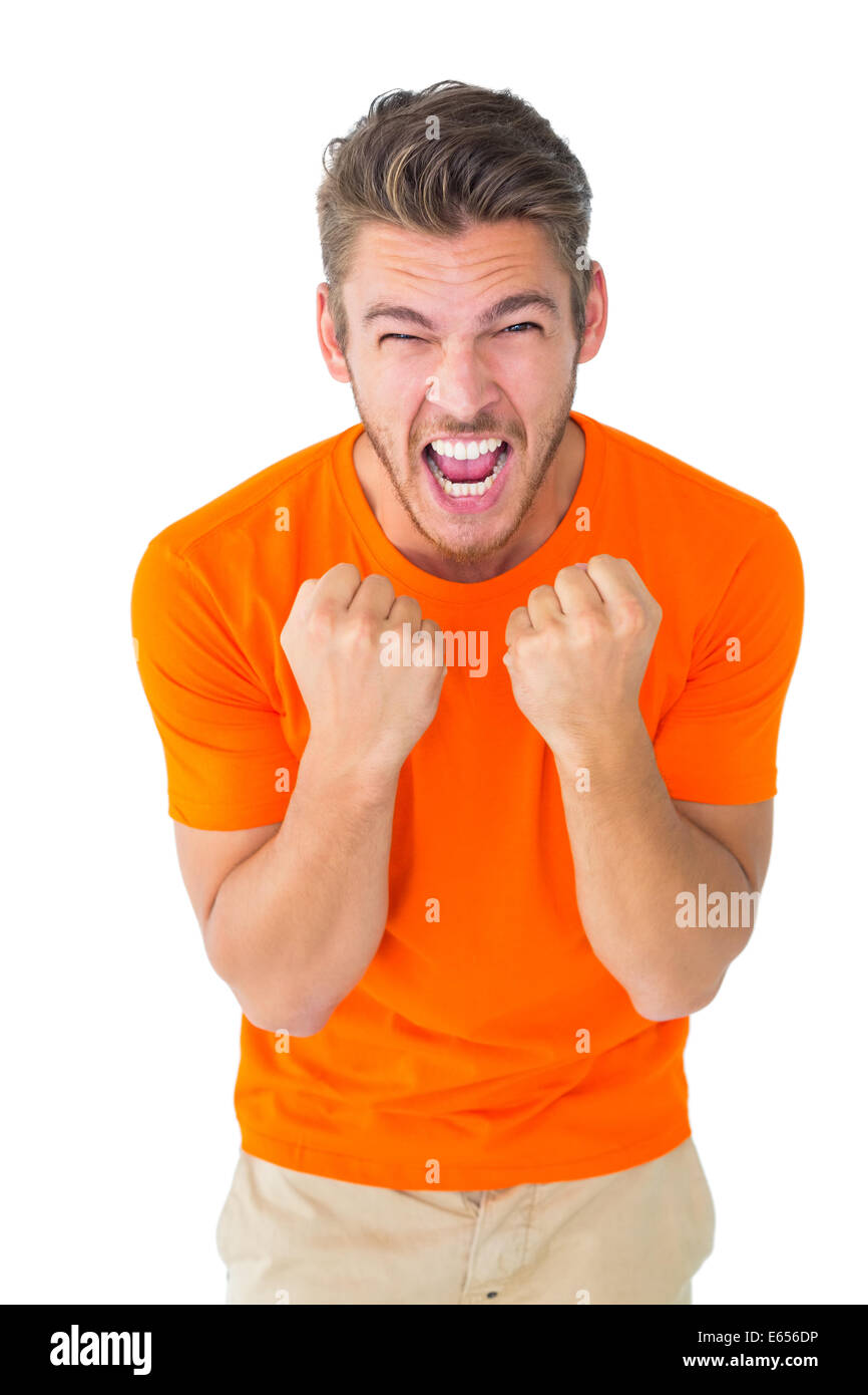 Excited man in orange cheering Stock Photo - Alamy