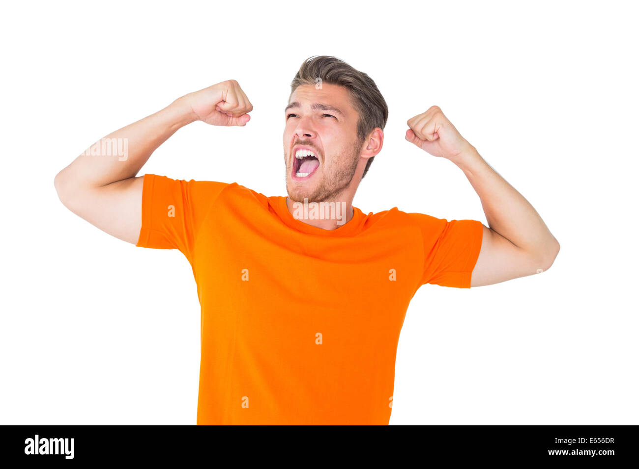 Excited man in orange cheering Stock Photo - Alamy