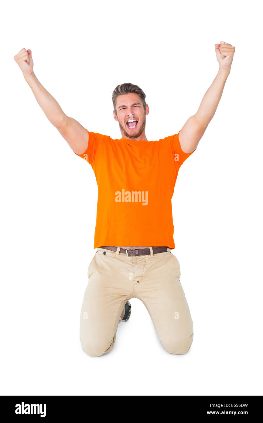 Excited man in orange cheering Stock Photo - Alamy
