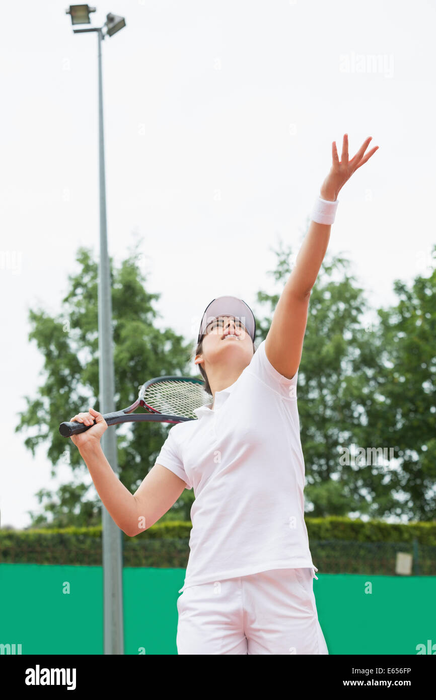 Focused tennis player serving the ball Stock Photo - Alamy