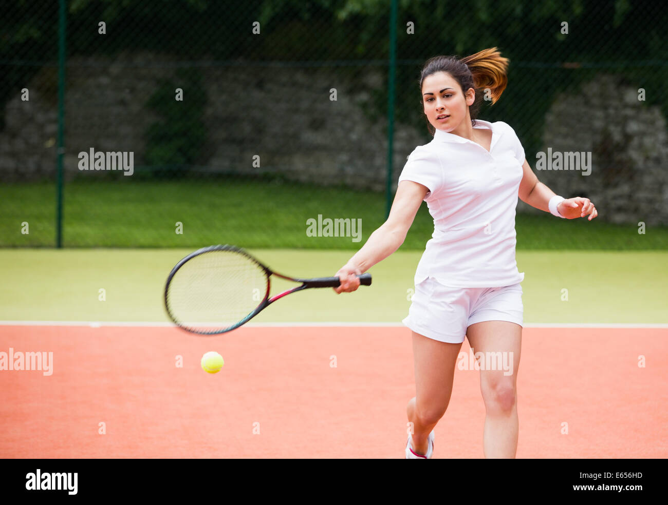 Caucasian woman hitting tennis ball hi-res stock photography and images ...