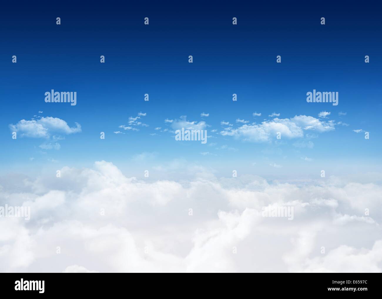 Bright blue sky over clouds Stock Photo - Alamy